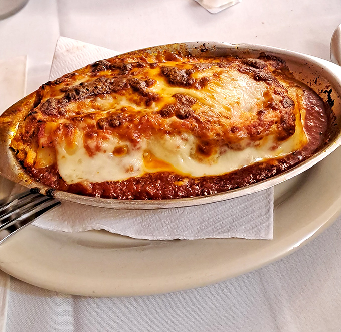 Lasagna that doesn't just arrive at your table—it makes an entrance, bubbling with cheese and promising comfort in every layer.