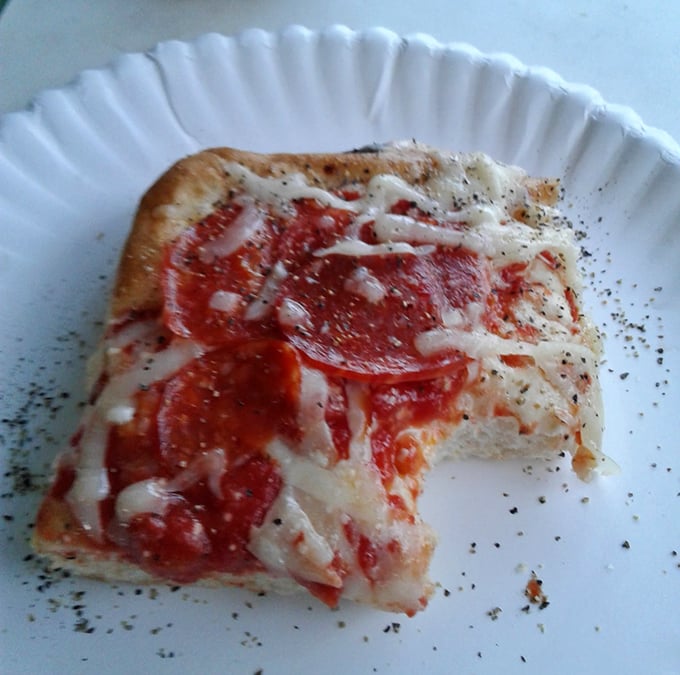 Simple perfection on a paper plate&mdash;this pepperoni slice doesn't need fancy presentation when the flavor does all the talking.