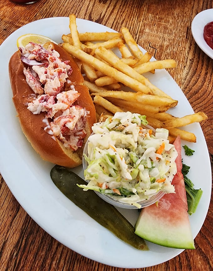 The lobster roll—a perfect marriage of sweet Maine lobster meat and buttery brioche—proves that sometimes the simplest pleasures are the most profound.