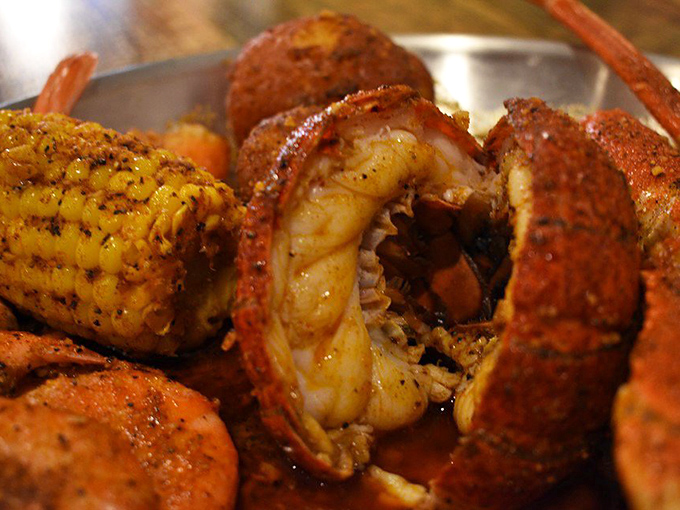 Nature's perfect design: the lobster tail. Tender meat nestled among potatoes and corn, all bathed in a spice blend that would make Neptune himself jealous.