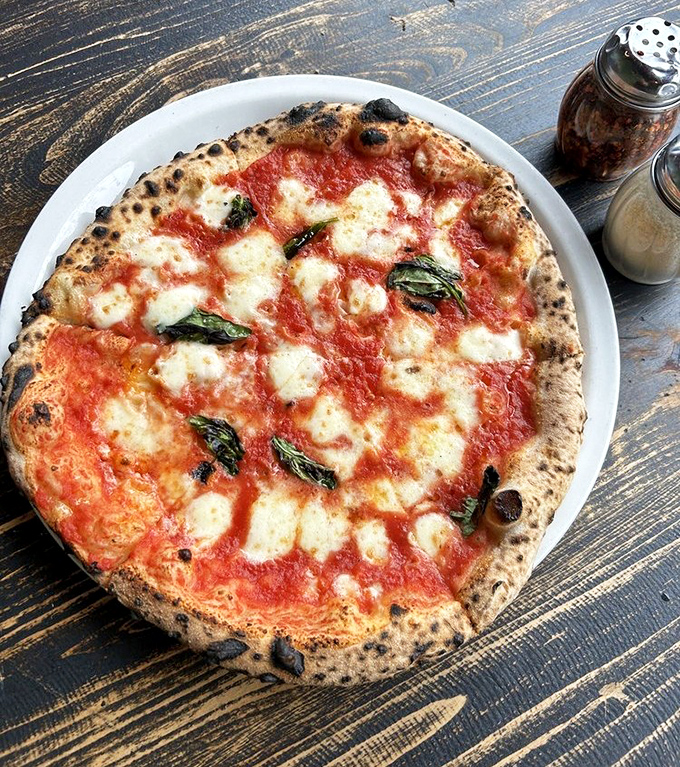 The Margherita&mdash;proof that when tomato, mozzarella, and basil meet a perfectly charred Neapolitan crust, magic happens on your plate.