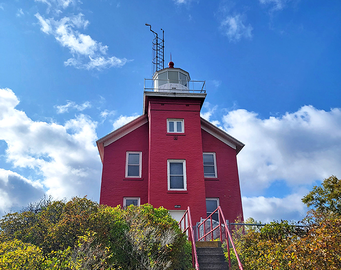 The Marquette Harbor Lighthouse stands proud in its crimson coat, a beacon that's been photobombing tourist pictures for generations.
