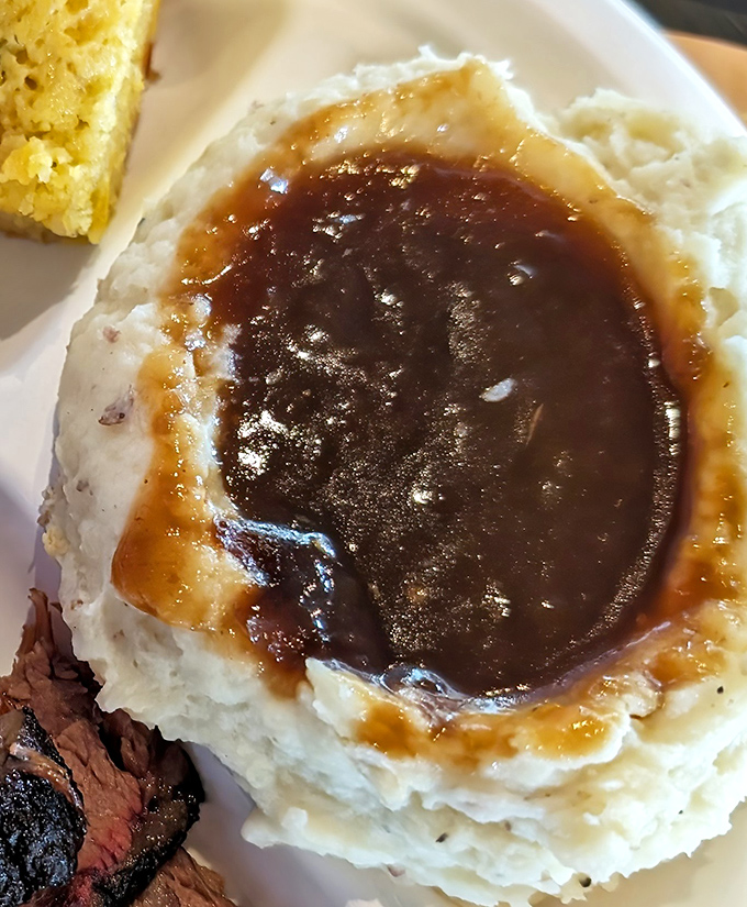 Mashed potatoes crowned with gravy like a royal wearing its finest jewels. The perfect sidekick to barbecue's superhero status.