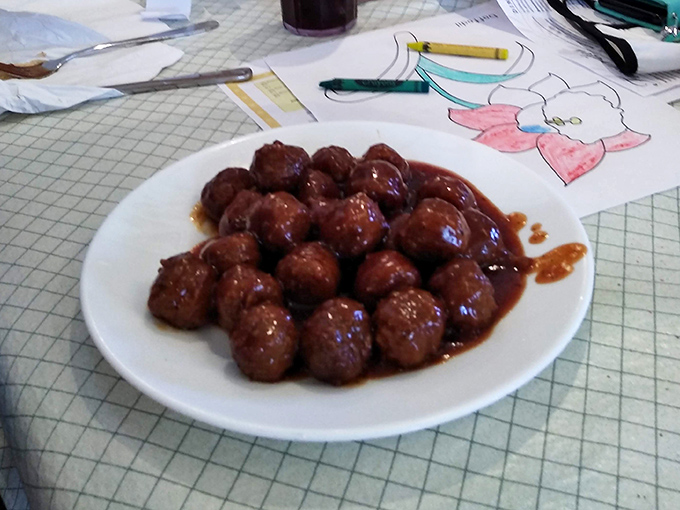 These meatballs aren't trying to be fancy Italian imports—they're proudly Midwestern, swimming in gravy that demands bread for sopping.