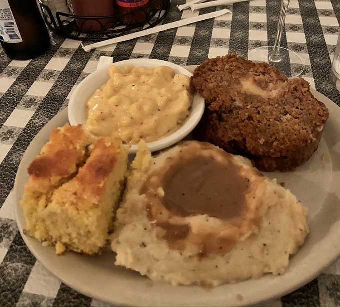 Meatloaf, mashed potatoes, and cornbread&mdash;the holy trinity of comfort. This plate doesn't just satisfy hunger; it wraps you in a culinary hug.