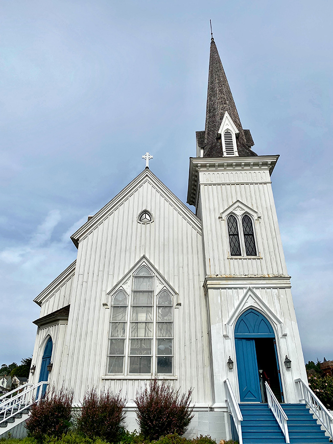 The Mendocino Presbyterian Church's blue doors practically beg you to enter, its white spire piercing the coastal sky since 1868.