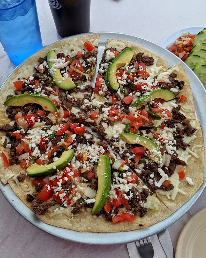 This isn't just a Mexican pizza&mdash;it's a fiesta on a tortilla, where avocado slices, fresh tomatoes, and crumbled cheese create a harmony of textures and flavors.