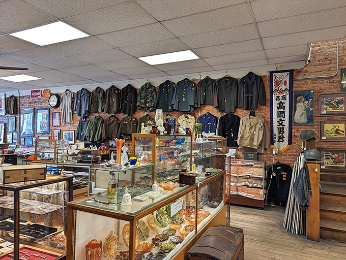 Military history hangs with quiet dignity. Each uniform tells a story of service, while glass cases below safeguard smaller pieces of Americana.