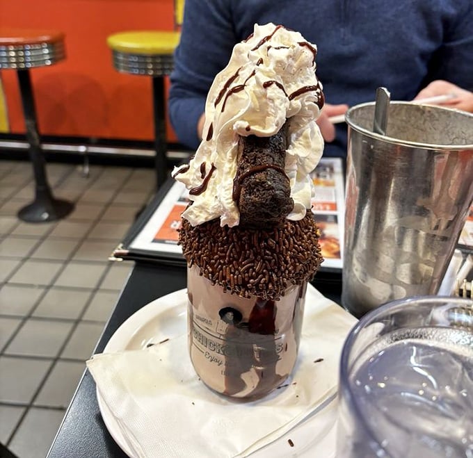 This isn't just a milkshake&mdash;it's a chocolate skyscraper topped with whipped cream, sprinkles, and what appears to be an entire brownie. Diets beware.