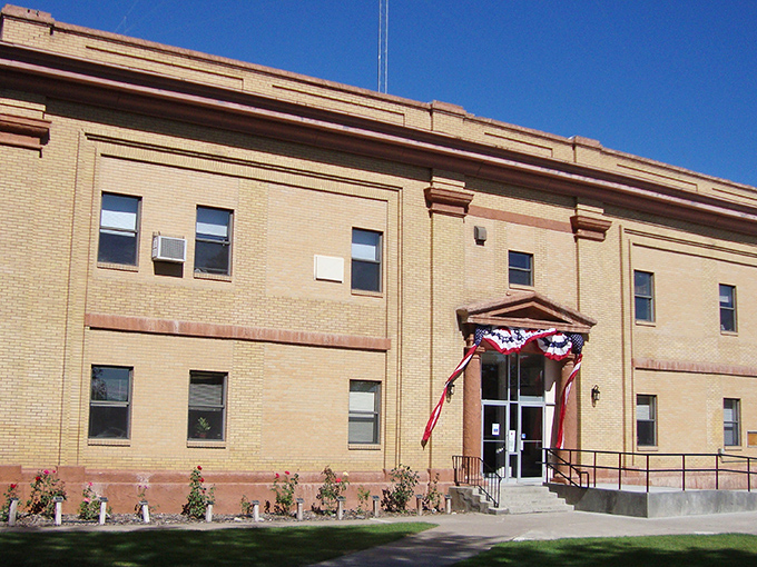 The Minidoka County Courthouse wears its patriotic bunting like a badge of honor, standing dignified as it has through decades of local history.
