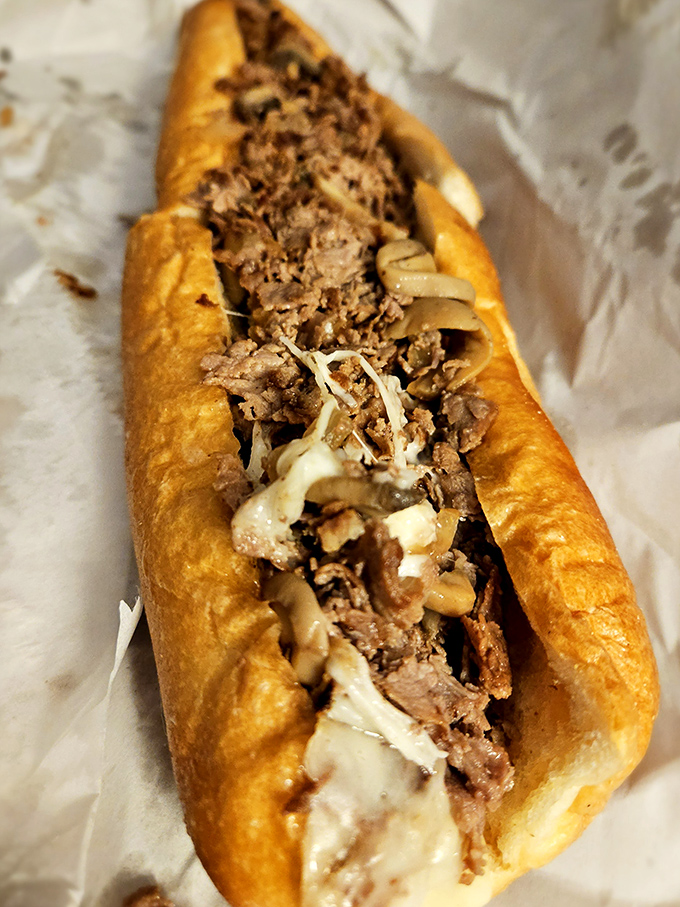 Behold the cheesesteak in its natural habitat – a perfect marriage of meat, melted cheese, and those magical caramelized onions.
