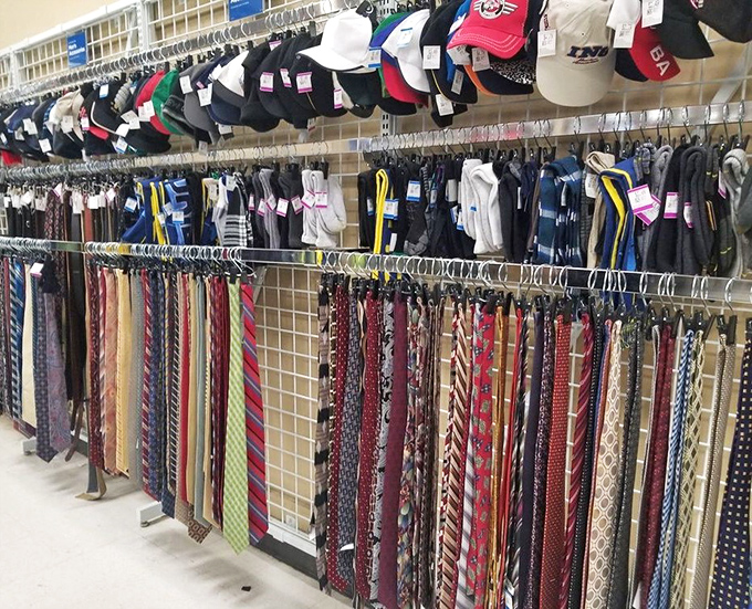 The necktie section: where power ties from corner offices enjoy retirement alongside whimsical patterns that once expressed someone's personality on casual Fridays.