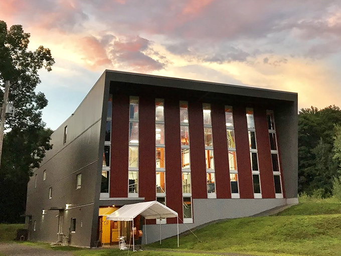 The New England Center for Circus Arts building reaches skyward, a modern structure where gravity becomes merely a suggestion for brave performers.