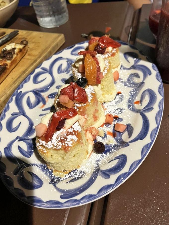 Olive oil cake topped with berries and powdered sugar looks almost too pretty to eat, but you'll manage somehow.