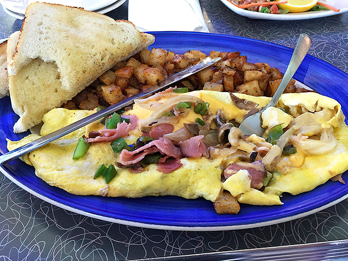 This isn't just an omelet&mdash;it's a carefully orchestrated medley of ingredients that somehow makes Monday mornings bearable. Home fries for the win!