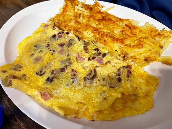 This omelet isn't just stuffed&mdash;it's having an identity crisis about whether it's a cheese delivery system or a mushroom and ham showcase.