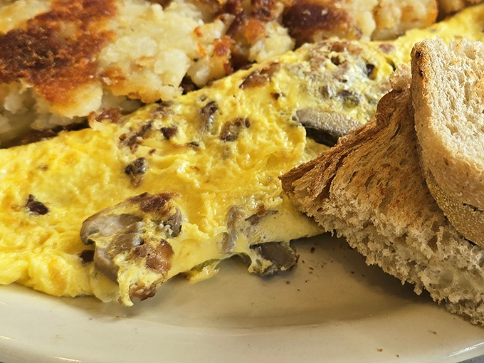 Breakfast alchemy at its finest&mdash;an omelette studded with savory morsels alongside perfectly browned hash browns and hearty toast. Morning glory on a plate.