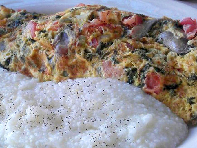 This isn't just an omelet; it's an architectural marvel of eggs cradling a treasure trove of fillings that would make any breakfast enthusiast weak at the knees.