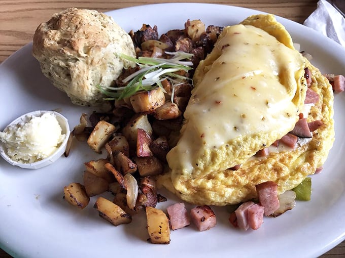 An omelet that's been to finishing school &ndash; perfectly folded, generously filled, and keeping excellent company with those seasoned potatoes.