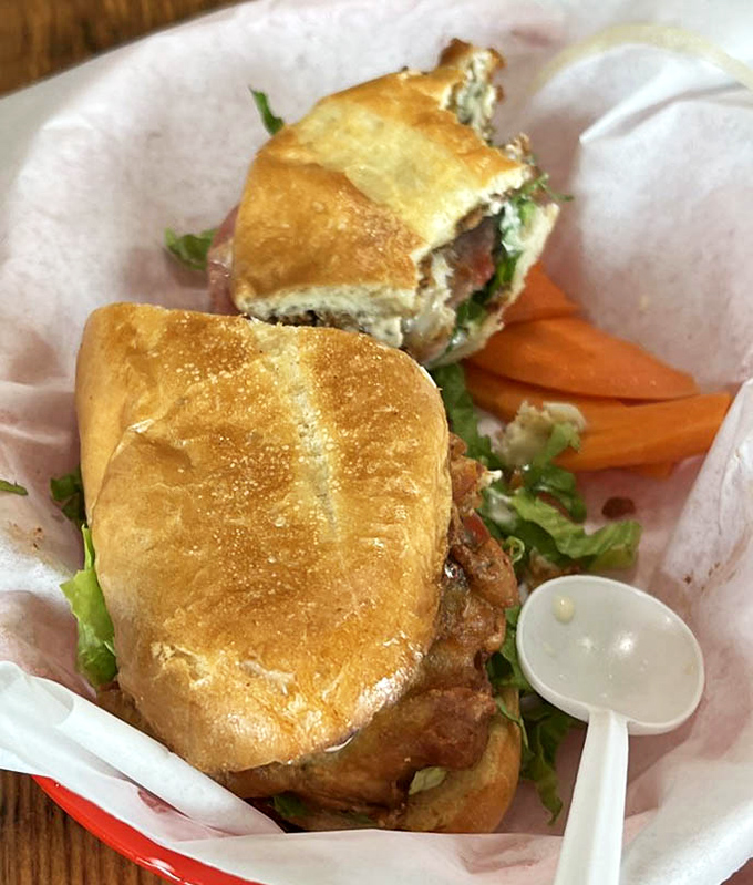 A sandwich that would make Poseidon jealous—crispy seafood nestled in a golden roll with fresh greens and a sauce worth diving in for.