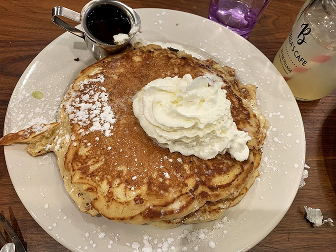 These aren't just pancakes&mdash;they're fluffy golden discs of joy, crowned with whipped cream and waiting for maple syrup's sweet embrace.