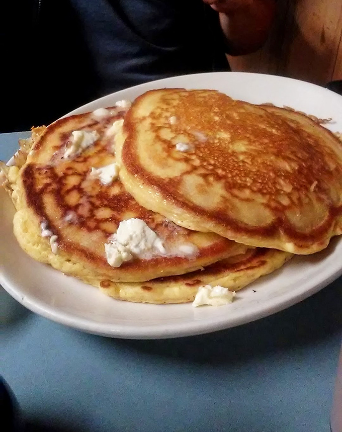 Golden-brown pancakes with melting butter pockets &ndash; the kind that make you wonder why anyone bothers with fancy brunch when this exists.