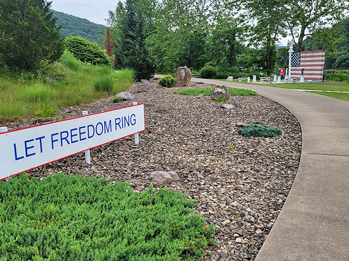 "Let Freedom Ring" proclaims the sign, as the pathway invites visitors to explore this patriotic peninsula where river meets forest.