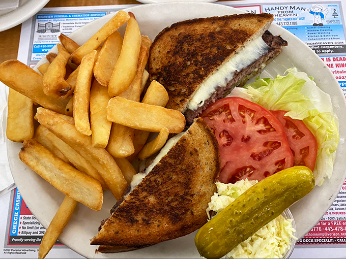 This patty melt doesn't just satisfy hunger&mdash;it abolishes it. The pickle stands guard, ensuring no bite is without a perfect tang counterpoint.