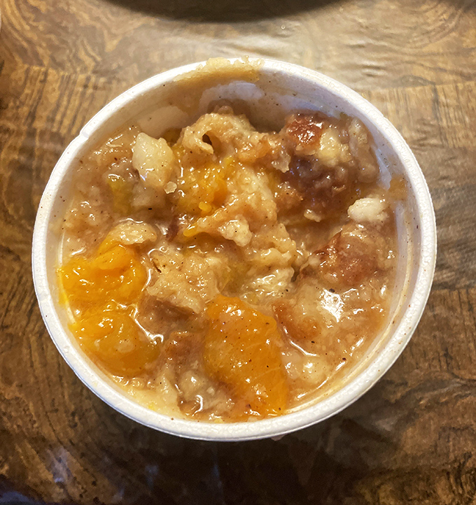 This peach cobbler isn't just dessert—it's a warm Georgia hug on a plate. The flaky crust and glistening filling tell stories of summer.