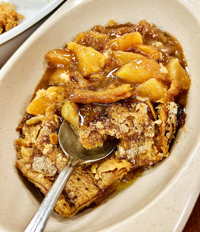 Peach cobbler that makes time stand still &ndash; golden Georgia fruit nestled under a buttery crust that shatters just right with each spoonful.