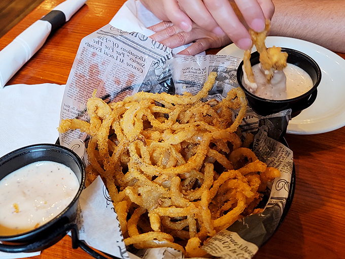 Those legendary onion rings aren't just appetizers; they're crispy, golden hoops of happiness that demand to be dunked.
