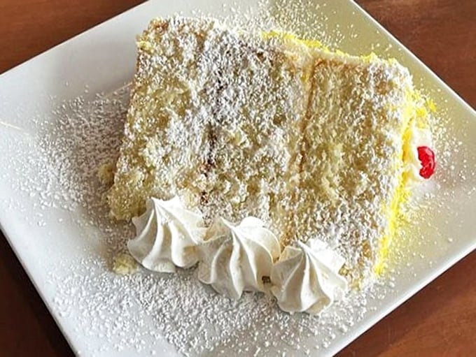 Layer cake perfection that makes you wonder if you should skip straight to dessert. Those delicate whipped cream rosettes are practically begging for a fork dive.