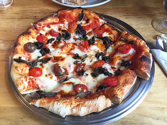 Pizza that respects its ingredients. Those blistered tomatoes and fresh basil aren't just toppings&mdash;they're the stars of a show that happens to be performed on perfect crust.