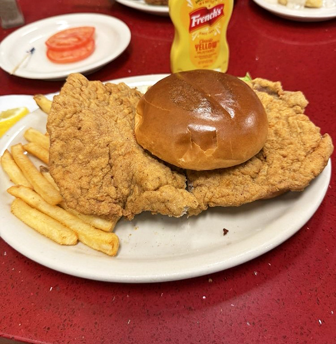 The pork tenderloin sandwich has clearly never heard of portion control&mdash;a golden-fried masterpiece that requires strategic bite planning.