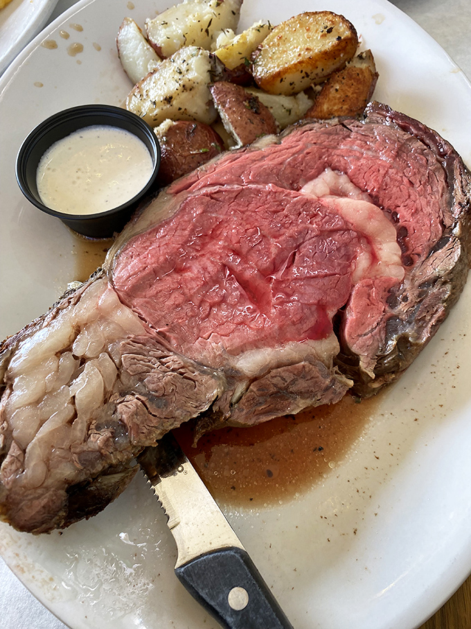 Prime rib so perfectly pink it could make a vegetarian question their life choices, accompanied by herb-roasted potatoes.