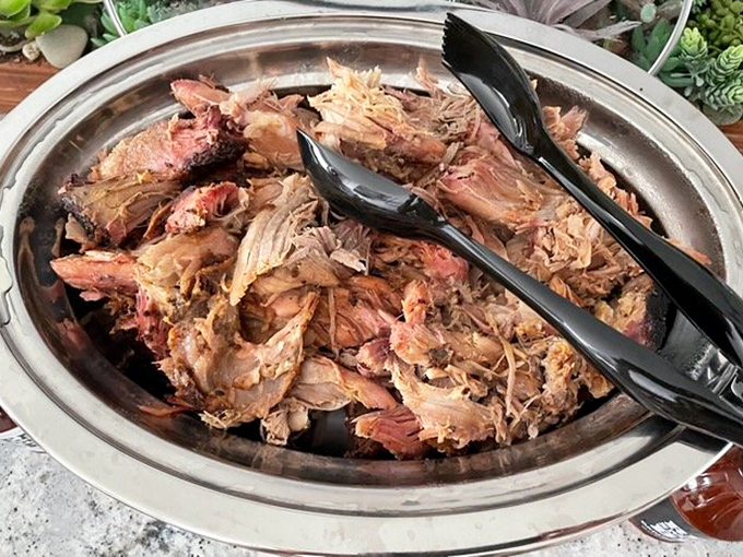 Pulled pork that's surrendered completely to time and temperature, ready to be piled high on a sandwich or savored solo &ndash; each strand a testament to patience.