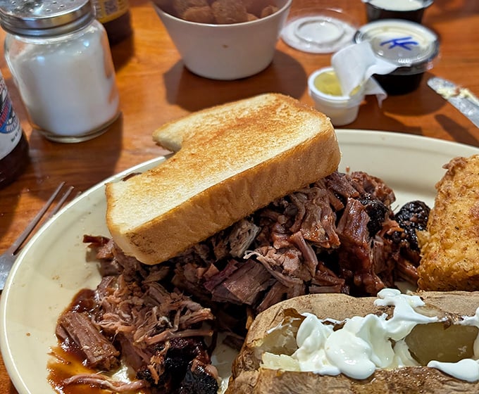 Pulled pork so tender it practically surrendered to the smoker, paired with Texas toast that's achieved golden perfection. Napkins required, not optional.