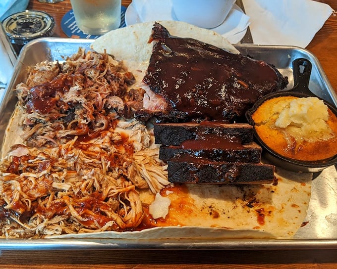 A metal tray becomes a canvas for BBQ artistry&mdash;pulled pork, ribs, and cornbread that would make a Texan tip their hat.