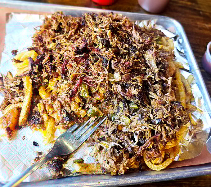 Pulled pork piled higher than your weekend to-do list. Each strand carries the perfect balance of smoke, spice, and that Oklahoma barbecue magic.