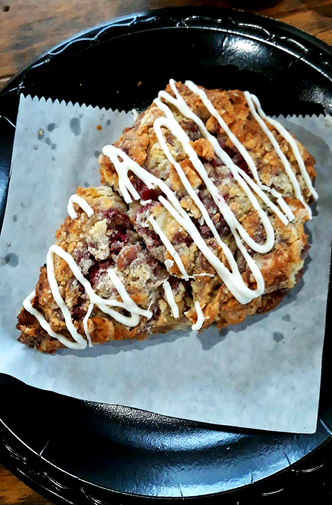 A berry-studded scone drizzled with icing that zigzags like a sugar highway across terrain that's somehow both crumbly and tender.