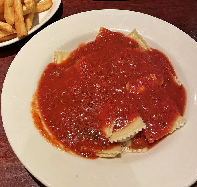 Ravioli swimming in that rich tomato sauce isn't just pasta&mdash;it's edible nostalgia that tastes like someone's Italian grandmother is in the kitchen.