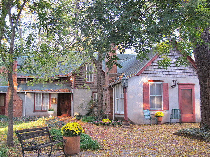 Autumn leaves frame this cozy cottage like a Swedish watercolor painting. The Red Barn Studio Museum offers a glimpse into artistic heritage.