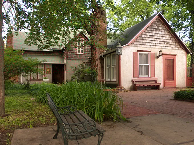 The Red Barn Studio Museum's pink cottage exterior makes you wonder if fairy tales relocated to Kansas permanently.
