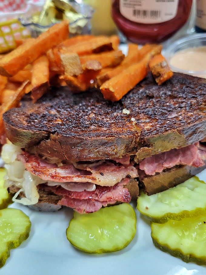 The Reuben sandwich here isn't messing around &ndash; layers of tender meat, sauerkraut, and melted cheese between perfectly grilled bread. Pickle perfection included.