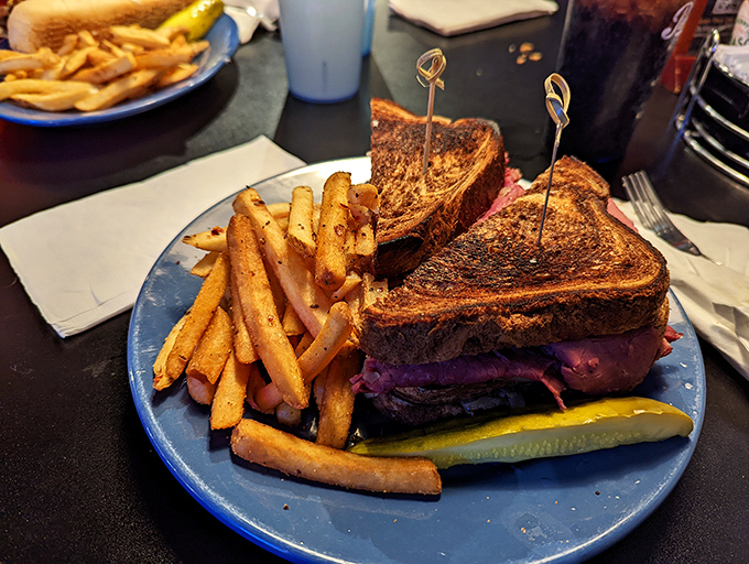 The Reuben arrives like a delicious architectural achievement&mdash;layers of corned beef, sauerkraut and Swiss on grilled rye with golden fries standing guard.