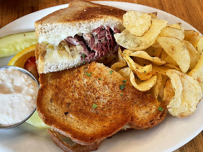 The Reuben showcases house-made corned beef on grilled bread with a side of chips - comfort food elevated to an art form.