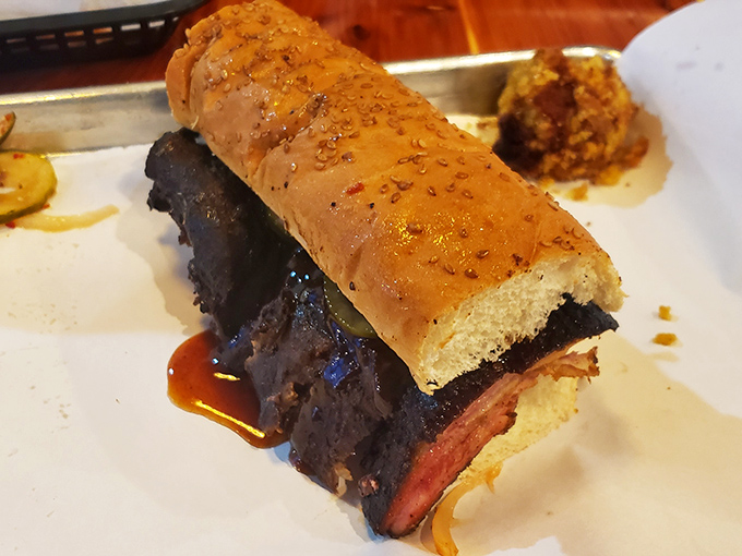 The kind of barbecue that renders conversation impossible. When your sandwich has this much character, silence becomes the appropriate response.