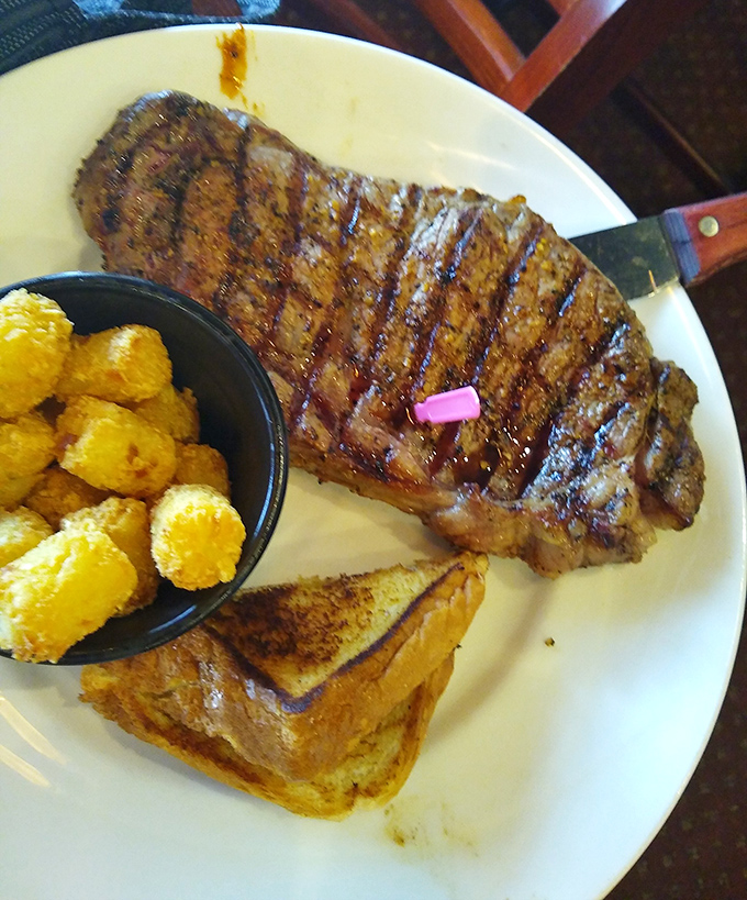 That pink marker stands proud on a perfectly grilled ribeye steak, with golden tater tots and buttery toast ready for the encore.