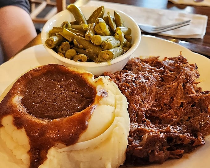 Roast beef so tender it practically surrenders to your fork, nestled beside mashed potatoes wearing a gravy hat and green beans that actually taste like vegetables.