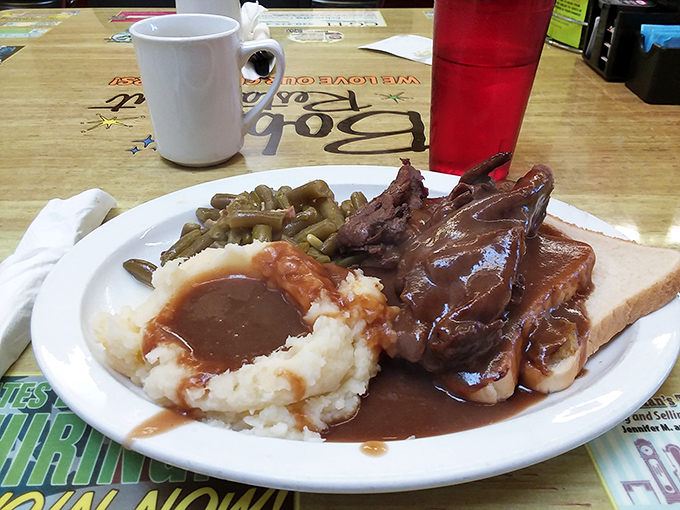 Comfort on a plate: fork-tender roast beef swimming in rich gravy alongside mashed potatoes that clearly never came from a box.